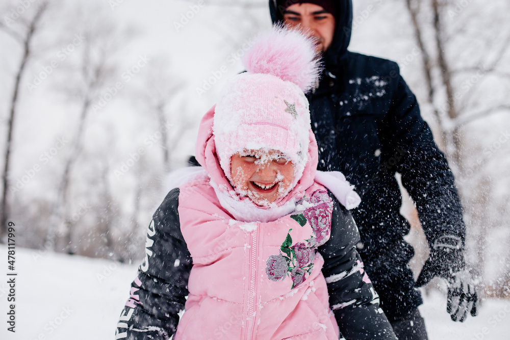 Closeup photo of female Russian kid who is about to cry because of snow ...