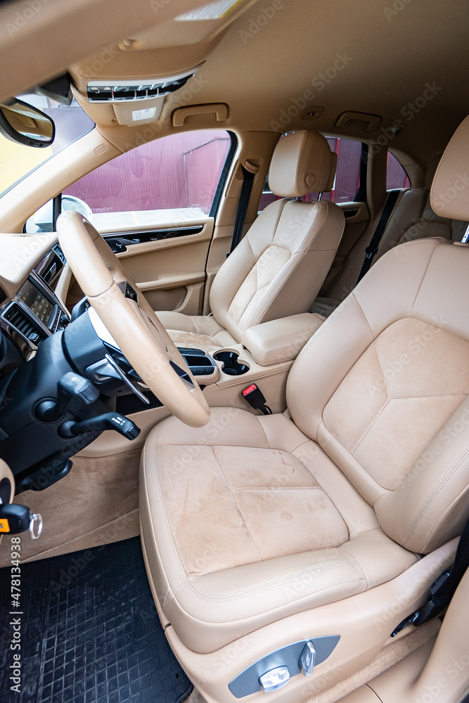 Car interior luxury. Beige comfortable seats, steering wheel, dashboard ...