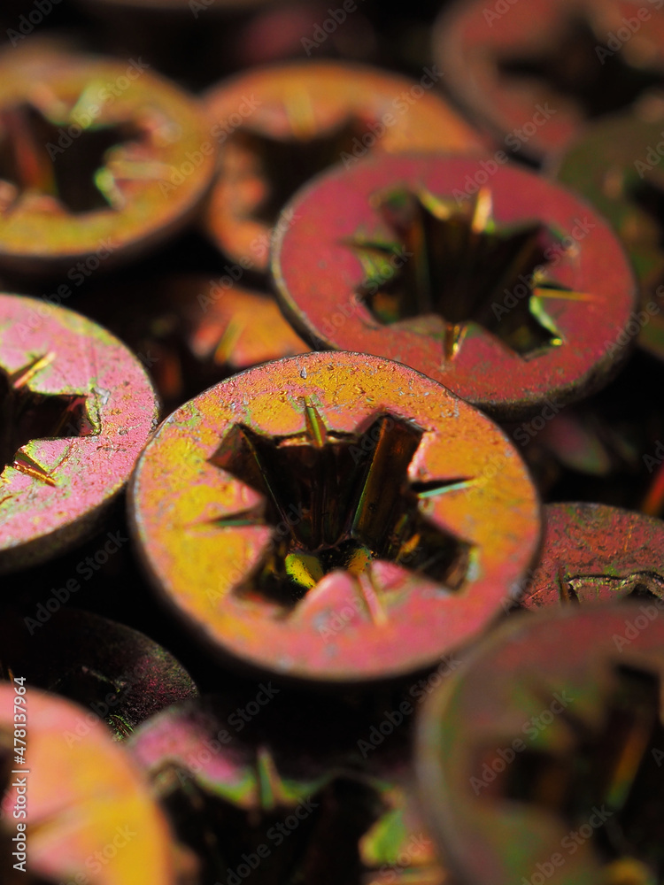 Anodized screw caps close-up. A vertical vivid illustration on the ...