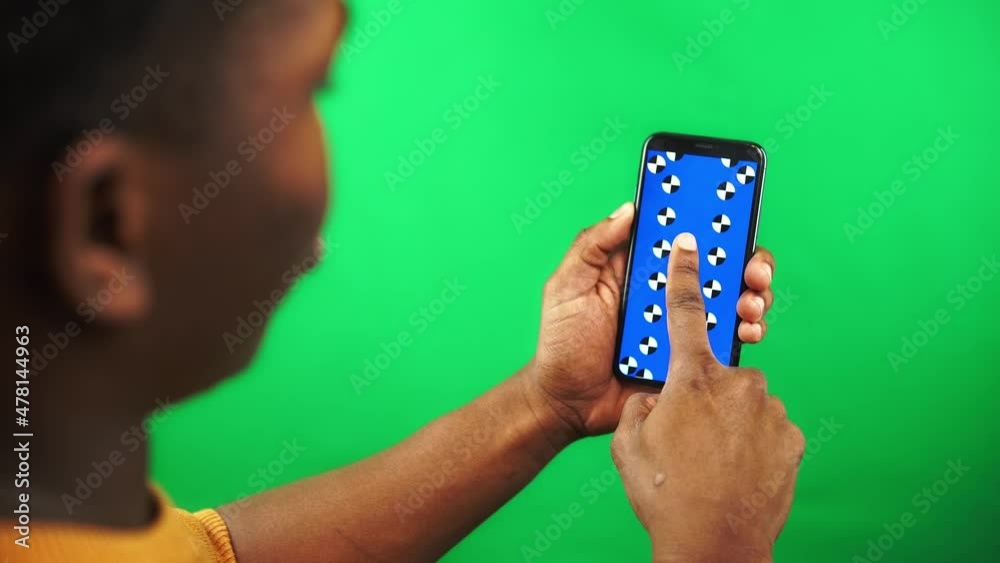 Video Stock Black man is scrolling pages on smartphone with tracking markers on display and ...