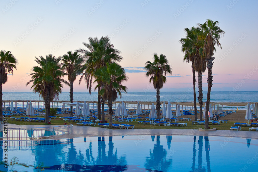 sun loungers for sunbathing on sea beach. sun loungers by blue sea in ...