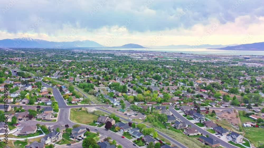 Aerial over Pleasant Grove Utah, late spring evening sunset with clouds ...
