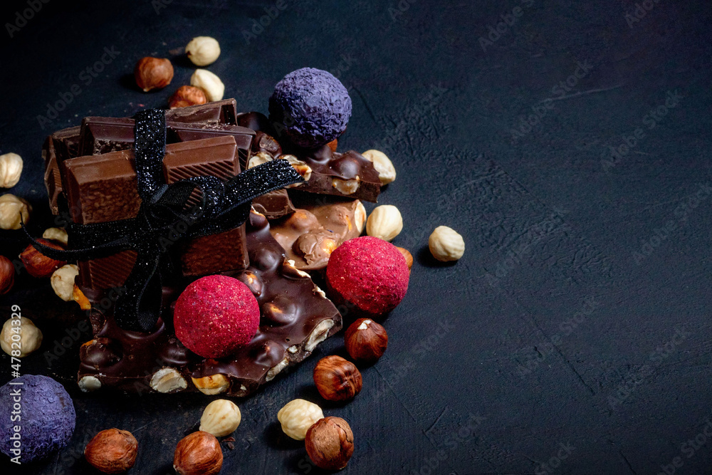 Chocolate bar, crushed pieces of dark chocolate and nuts. Praline ...