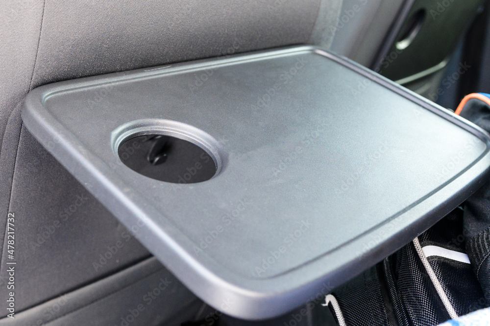 dining table in the car in the cabin, attached to the front seat behind ...