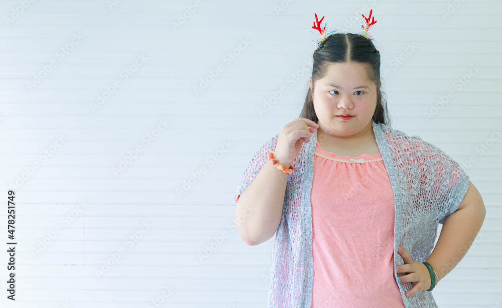 Portrait studio shot of Asian young cute chubby female down syndrome ...
