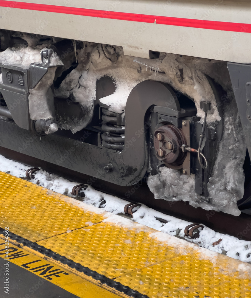 Train components iced up under railcar after days of snow and freezing ...