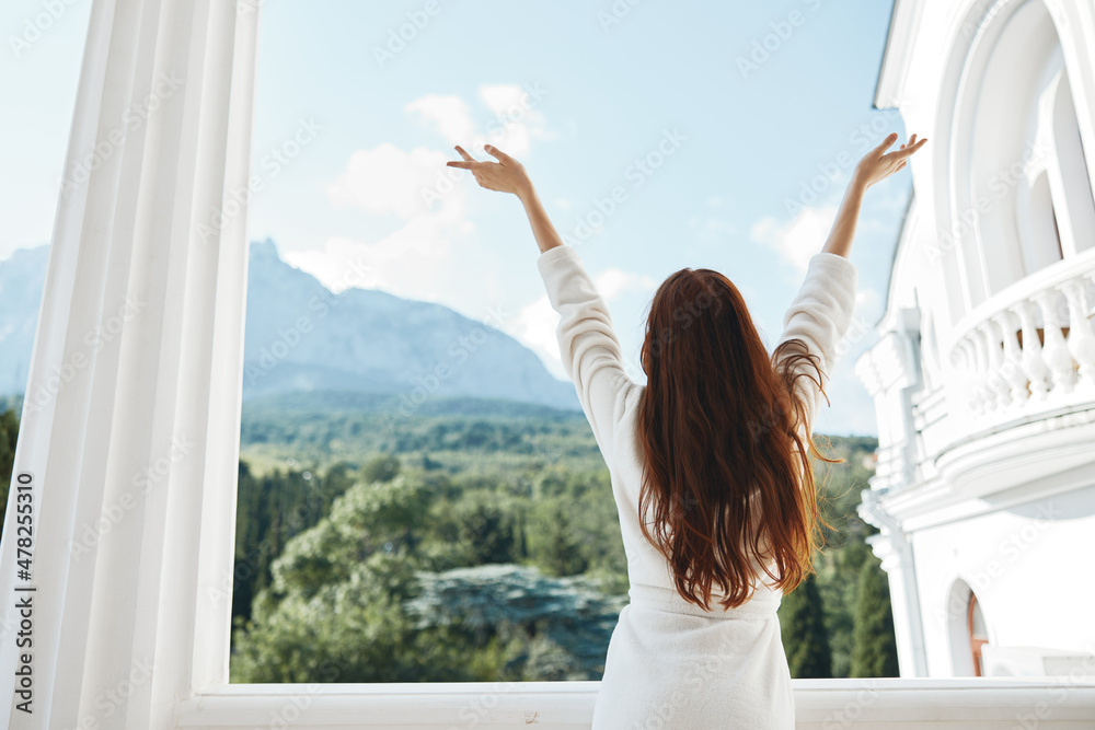 beautiful woman hands up on the balcony back view Stock Photo | Adobe Stock