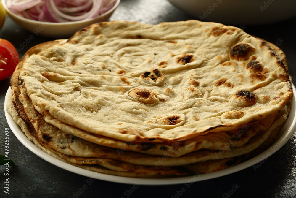 Indian roti- whole wheat flat bread served with onion salad and ...