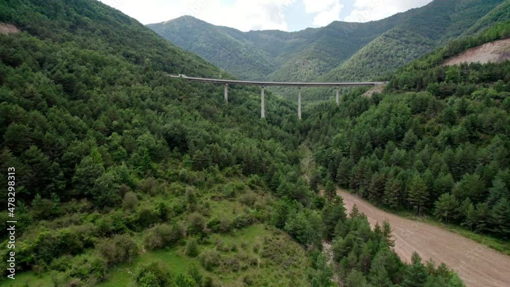 A bridge, a modern viaduct in the mountains with an asphalt road with ...