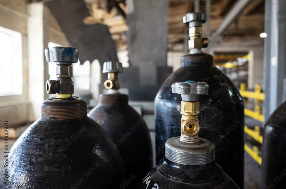 Compressed gas cylinders in the production room of an industrial plant ...