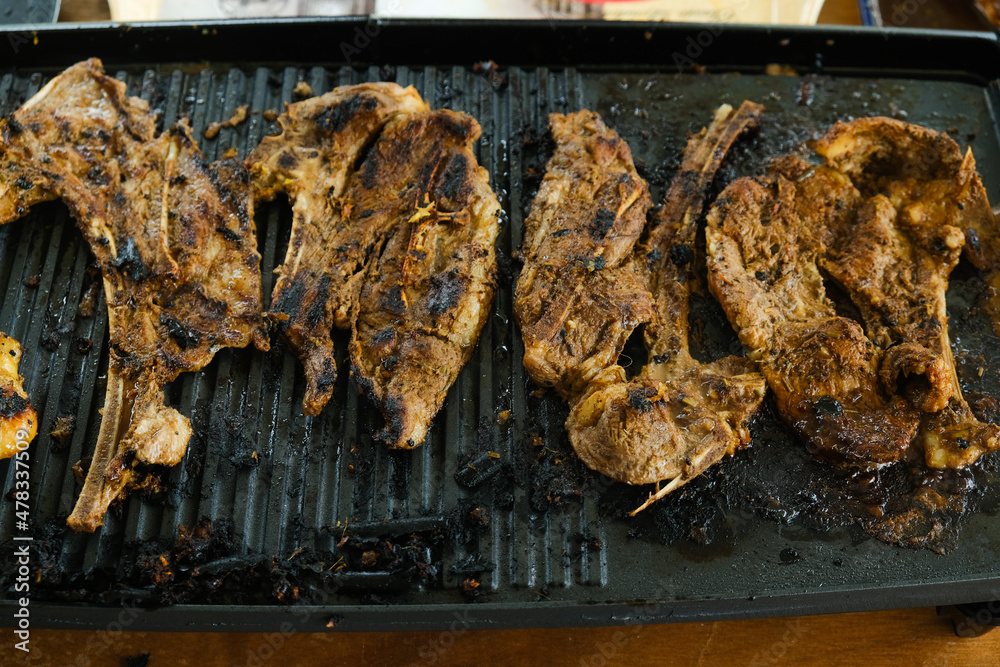 Selective focus picture of ready to eat mutton on the grille. Mutton is ...