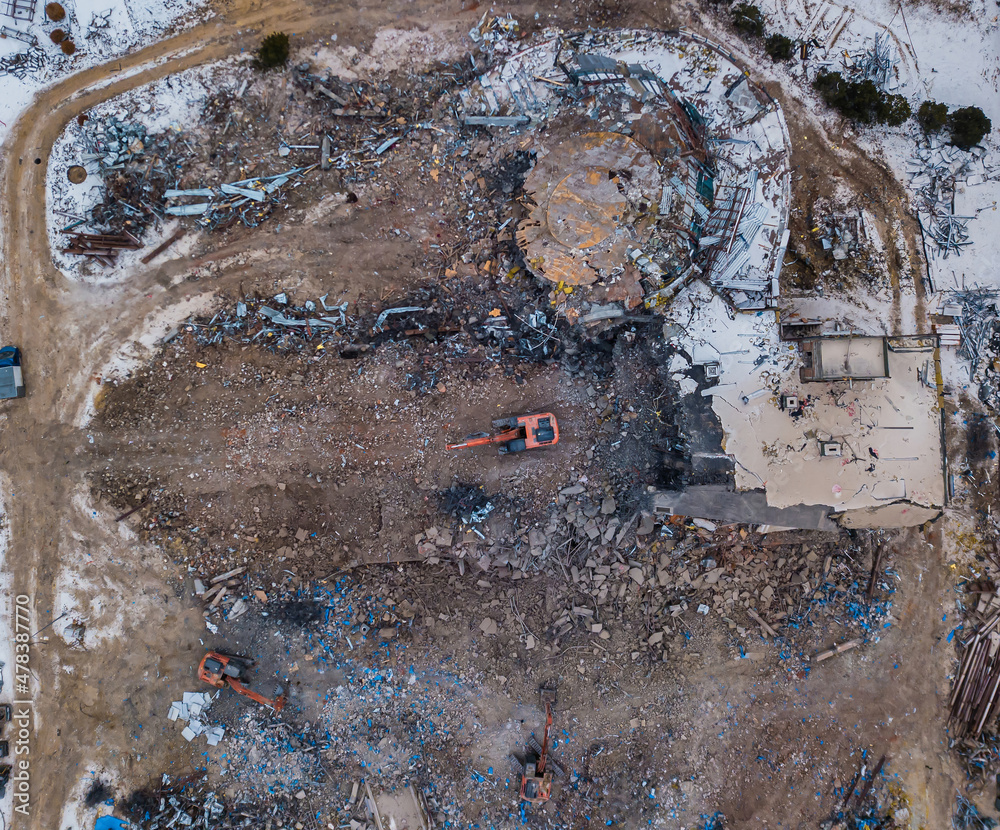 Heavy equipment being used to tear tearing down building construction ...