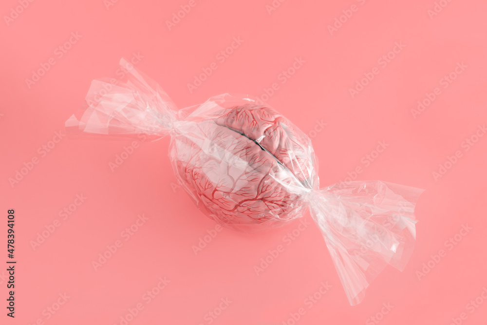 2022. Minimal satiric scene made of human brain model wrapped in ...