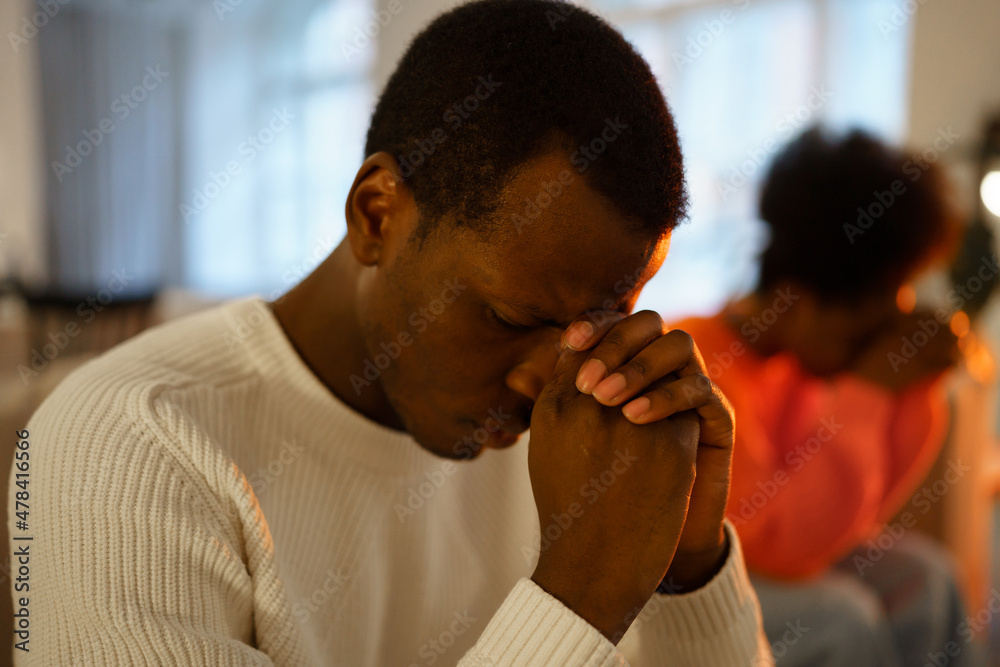 Selective focus of upset depressed african man with closed eyes feeling ...