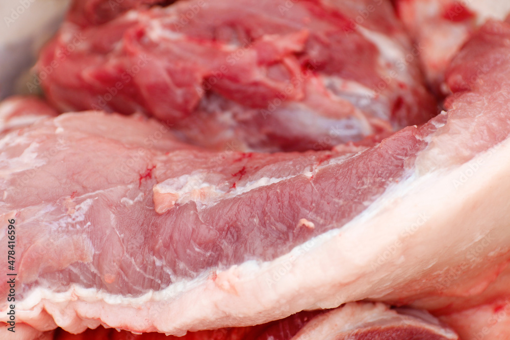 Defocus texture or background of tasty fresh meat of big, pork. Red ...