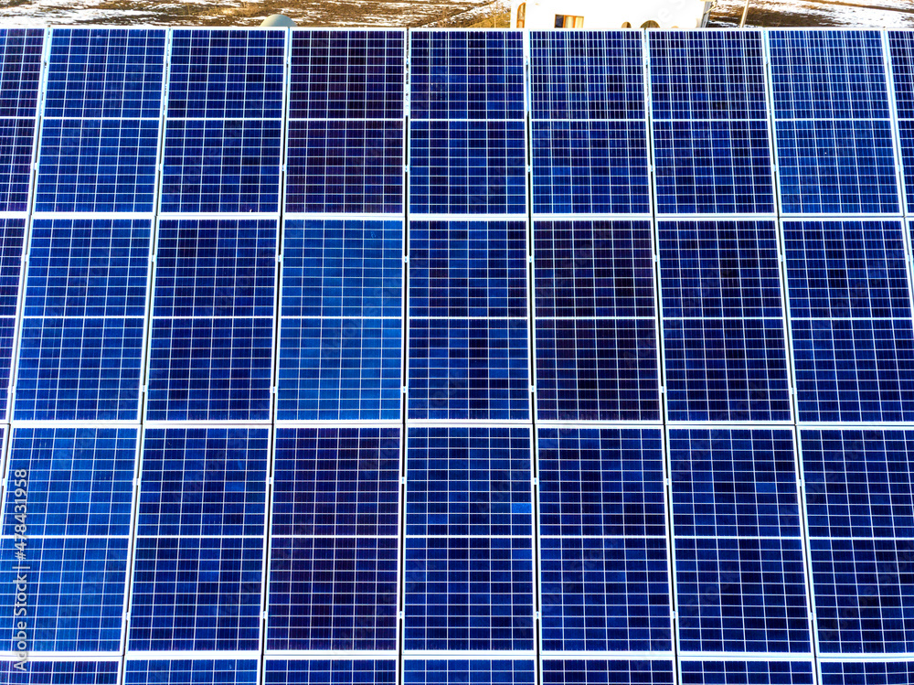 Close-up surface of lit by sun blue shiny solar photo voltaic panels ...