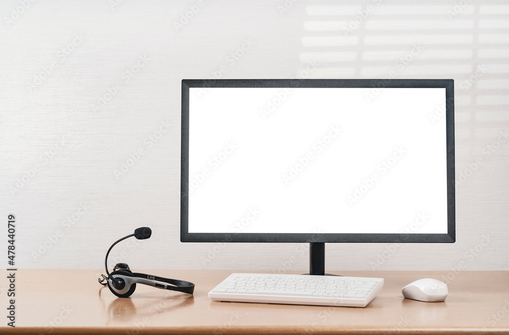 Front view of plain workspace with modern computer and headset ...