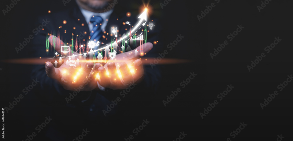 Businessman holding graph virtual with icons for analyzing sales data ...