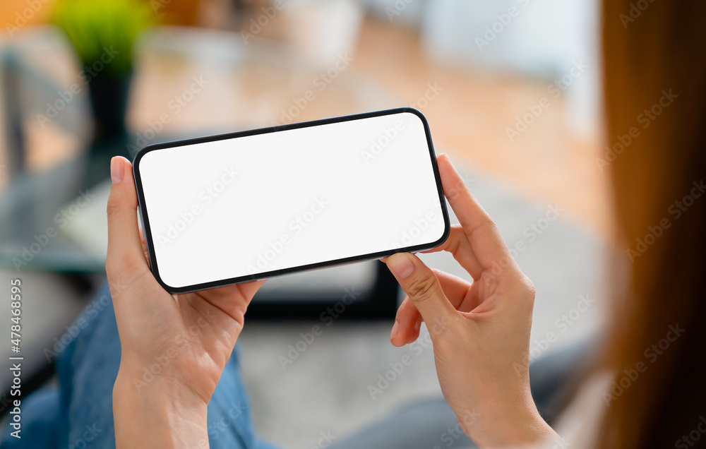 Hand holding smartphone mockup of blank screen. Take your screen to put ...