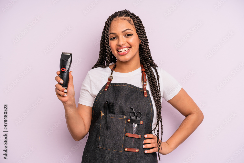black afro woman smiling happily with a hand on hip and confident ...