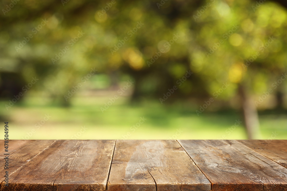 Empty rustic table in front of countryside background. product display ...
