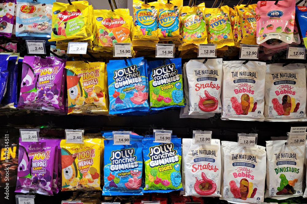 Various choices of imported sweet candy display on shelf in Mercato ...