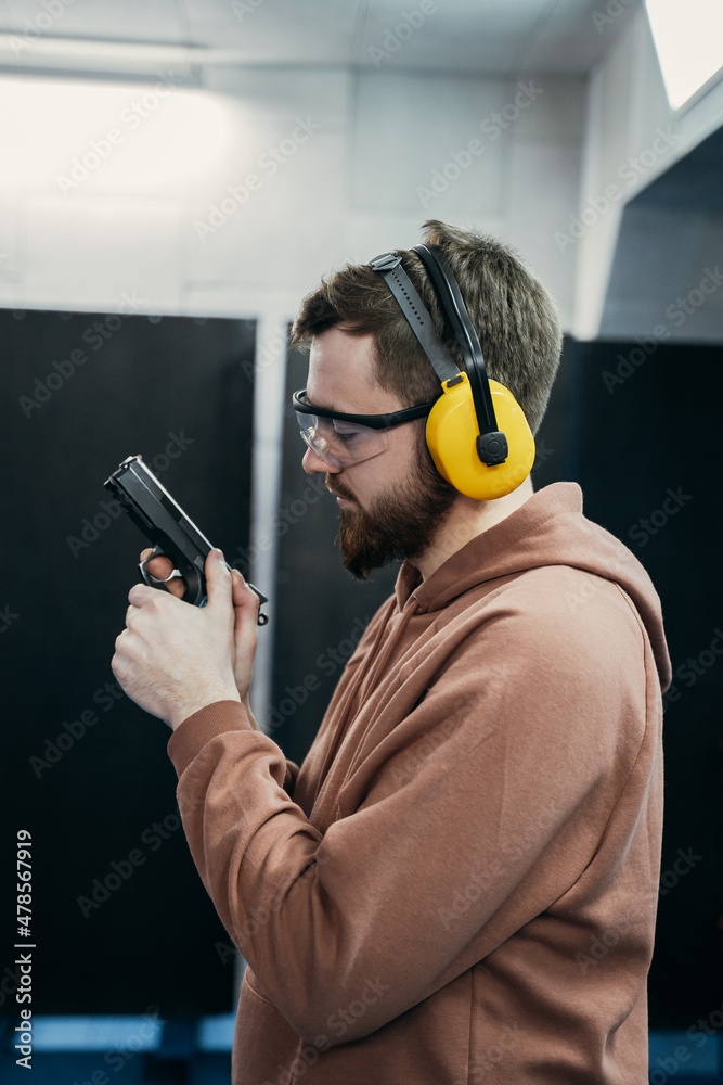 Face profile of a serious man holding a short-barreled weapon Stock ...