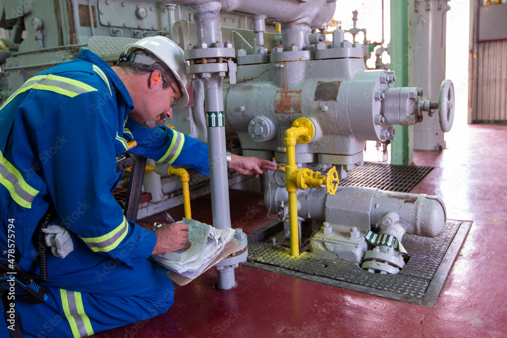 Male worker checking pipes in gas plant Stock Photo | Adobe Stock