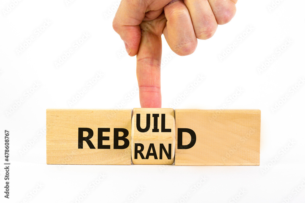 Rebrand and rebuild symbol. Businessman turnsa the wooden cube and ...