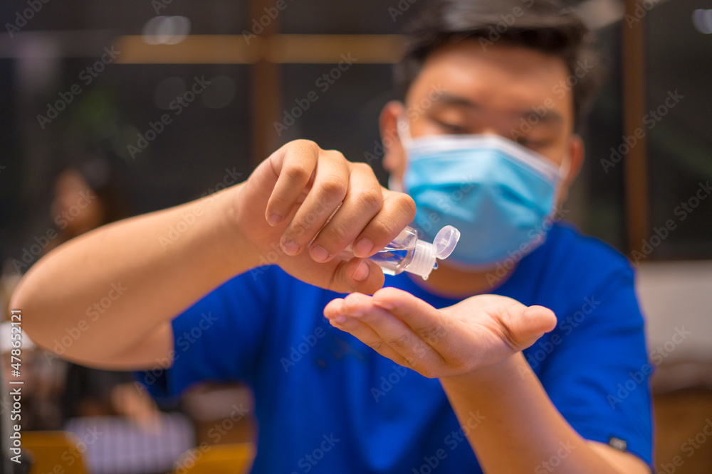 Close up hand sanitizer man applying sanitizing gel liquid rubbing ...