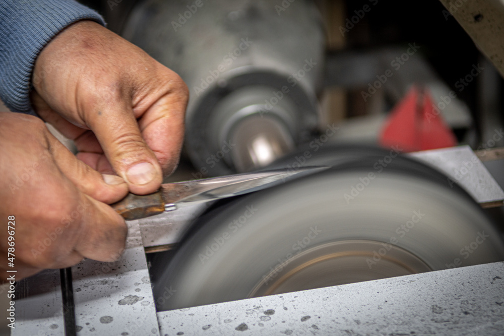 Isolated close up of chef knife sharpening, honing and stropping ...