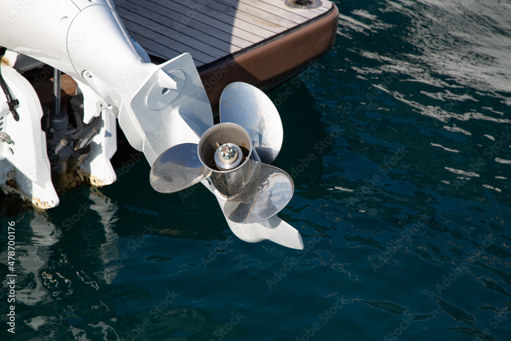 Three-bladed yacht engine propeller with rust spots on it. Shiny metal ...