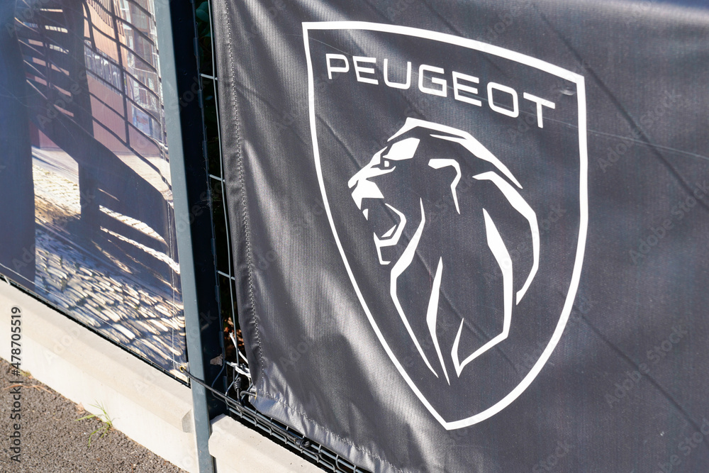 Peugeot car sign brand new design and text logo lion front of store ...