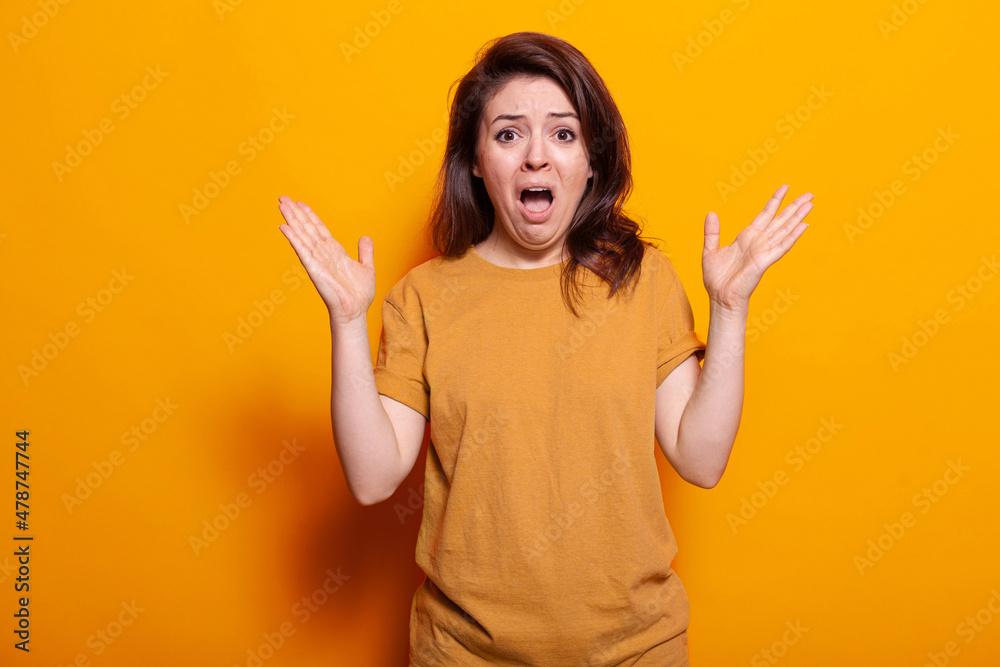 Frightened person showing shocked facial expression, standing over ...