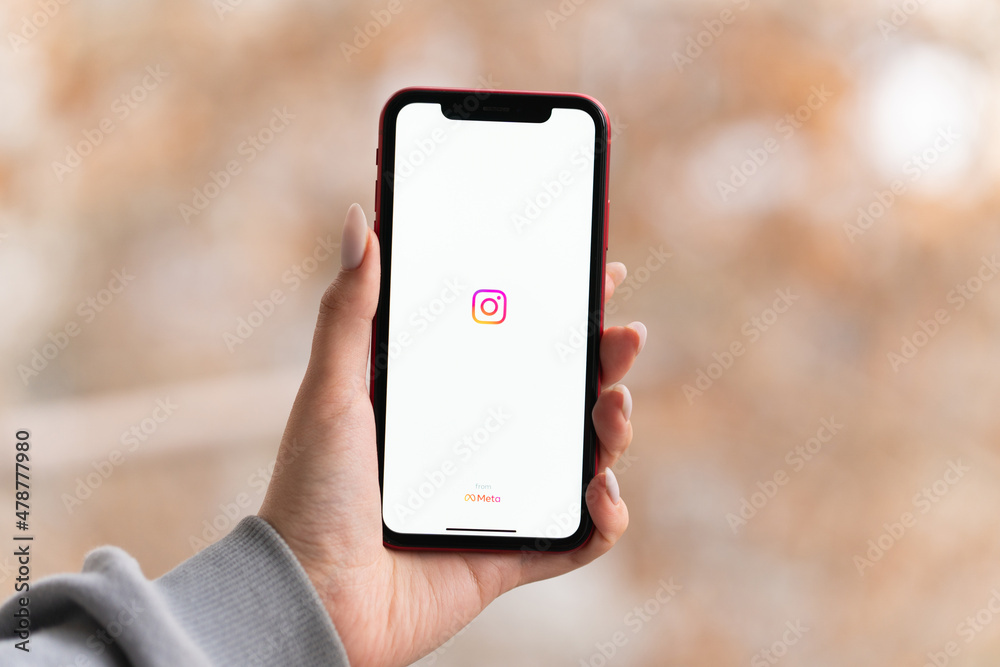 Young woman hand holding new apple Iphone with logo of Instagram ...