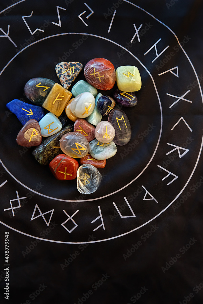 Rune stones with symbols for fortune telling on abstract black altar ...