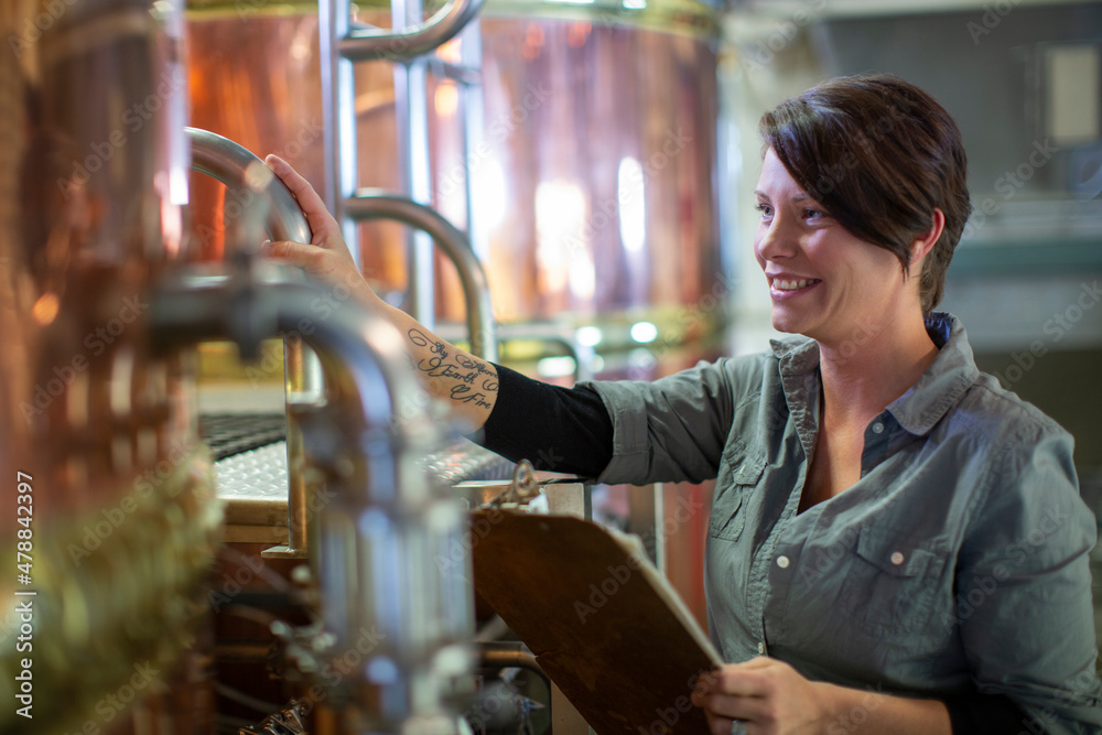 Portrait of brewery worker leaning on copper still Stock Photo | Adobe ...