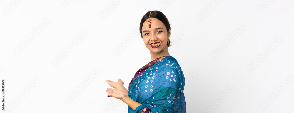 Young indian woman isolated on white background extending hands to the ...