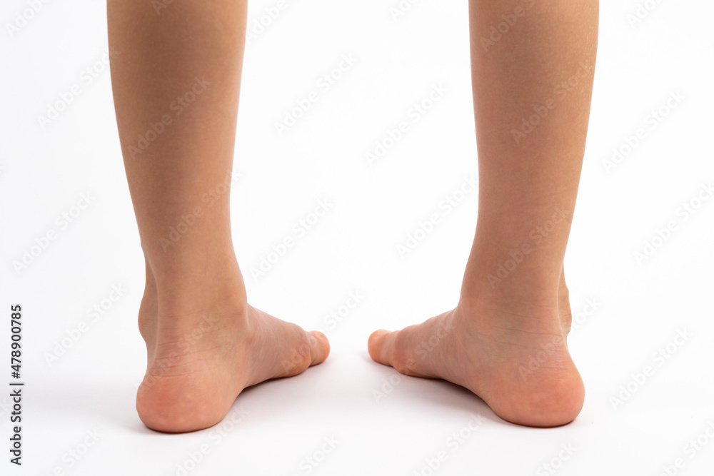 children's feet on a white background rear view, the concept of ...