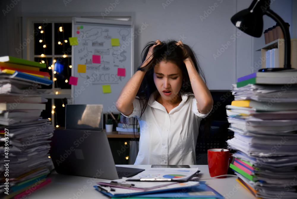 Stressed exhausted asian woman sitting at office desk and working ...