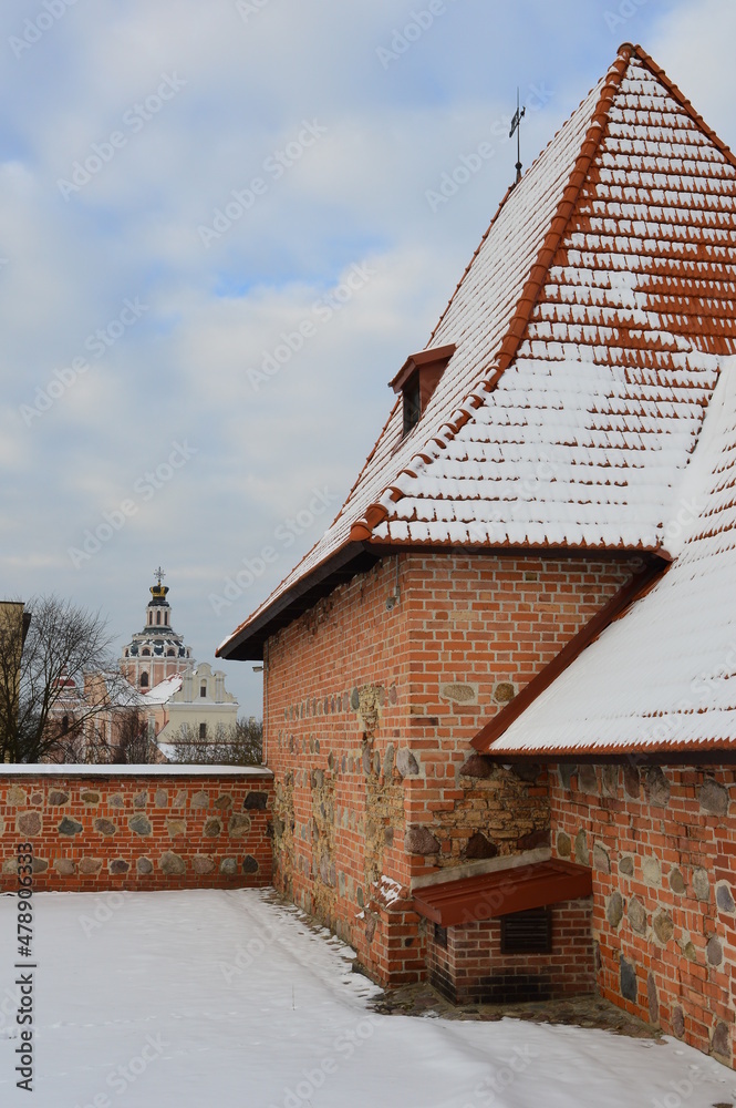 Vilnius Basteja fort and old town in winter time. Red brick and ...