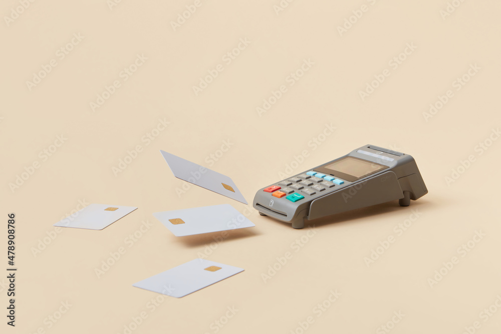 Pos terminal with falling credit cards Stock Photo | Adobe Stock