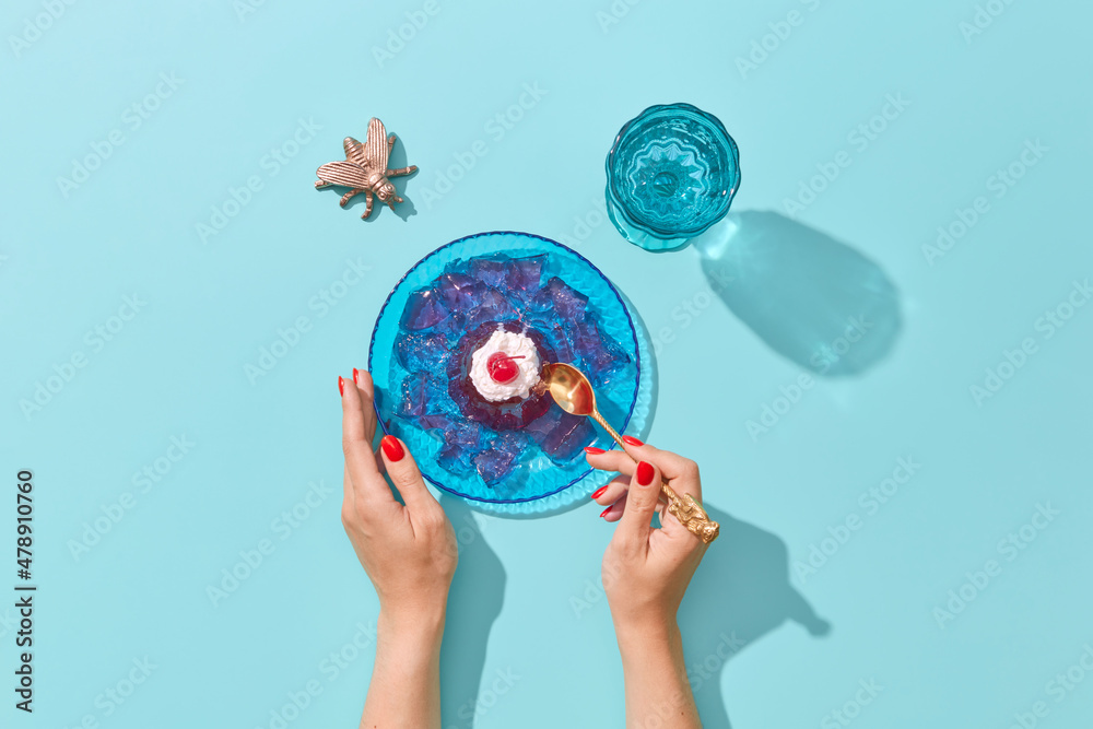 Crop woman eating gelatin dessert Stock Photo | Adobe Stock