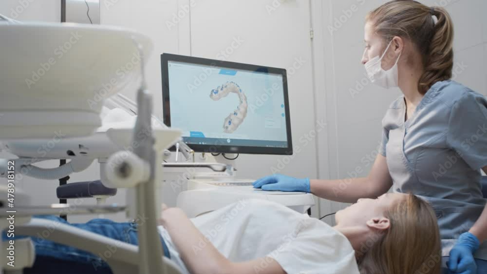 Doctor scans the patient's teeth in the clinic. The dentist holds in ...