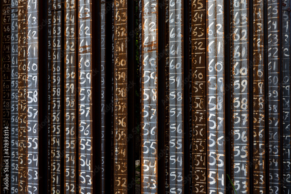 Steel pilings with numbers written on them Stock Photo | Adobe Stock
