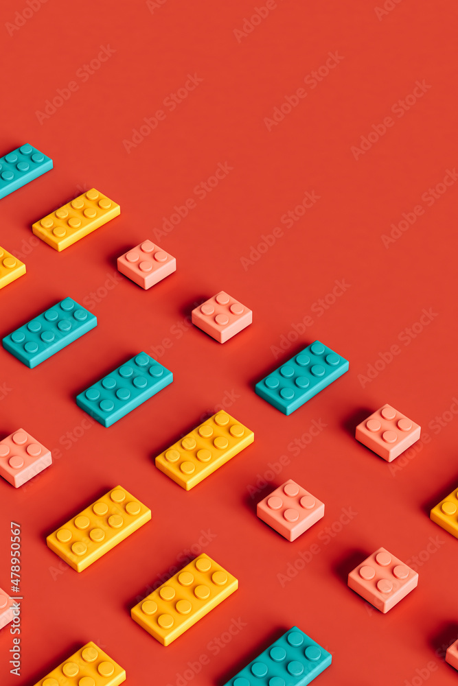 Colorful building blocks on red Stock Photo | Adobe Stock