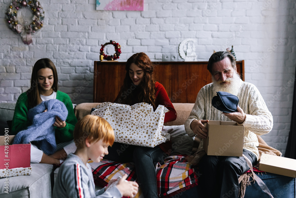 Happy family unwrapping Christmas gifts in home Stock Photo | Adobe Stock Happy family unwrapping Christmas gifts in home Stock Photo | Adobe Stock