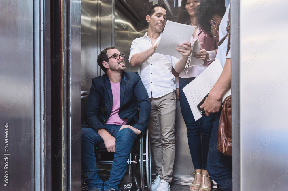 group of people with man in wheelchair inside an elevator Stock Photo ...