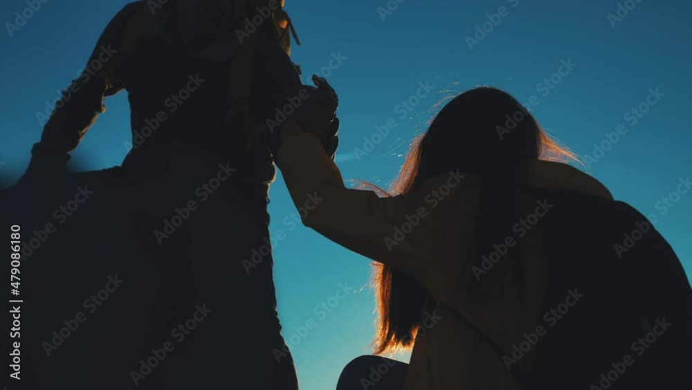 help team concept. couple team silhouette of two climber stretching a ...