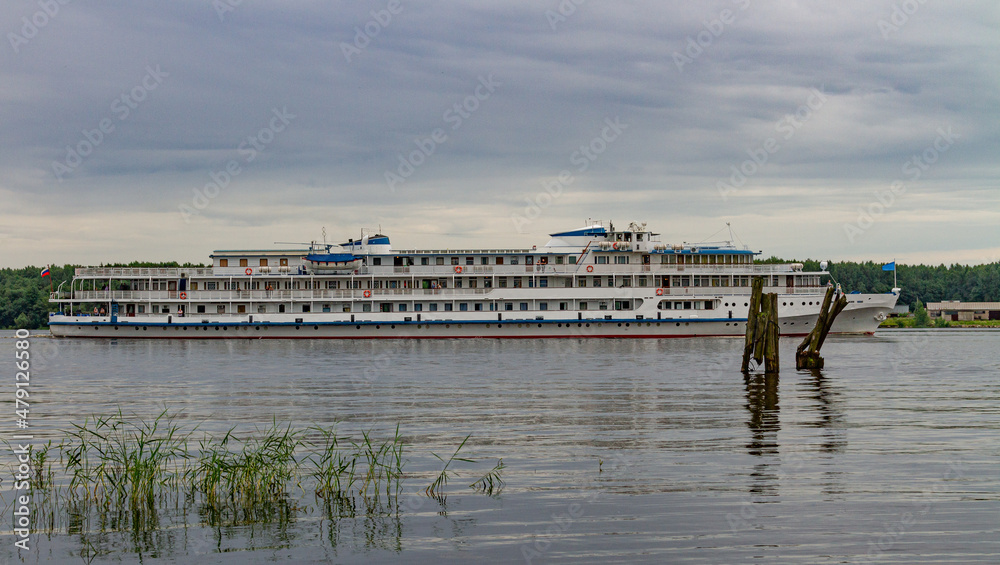 Cargo ships sail along the river. Large cargo barges carrying inland ...